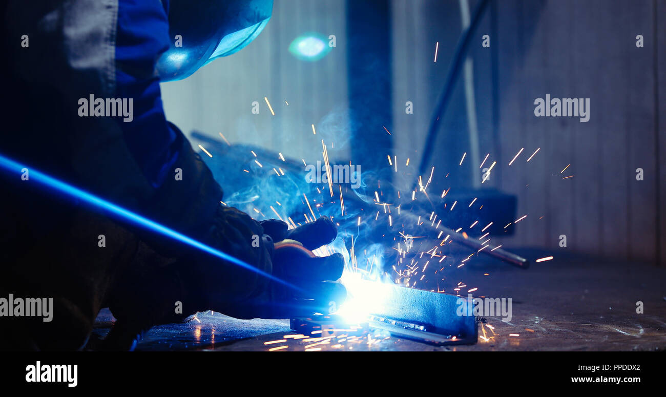 Industrial Worker at the factory welding metal closeup Stock Photo - Alamy