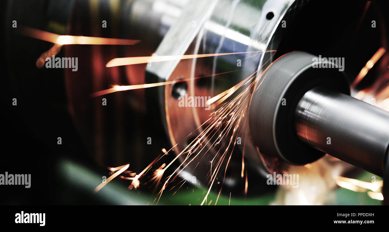 sparks flying while machine griding and finishing metal Stock Photo - Alamy