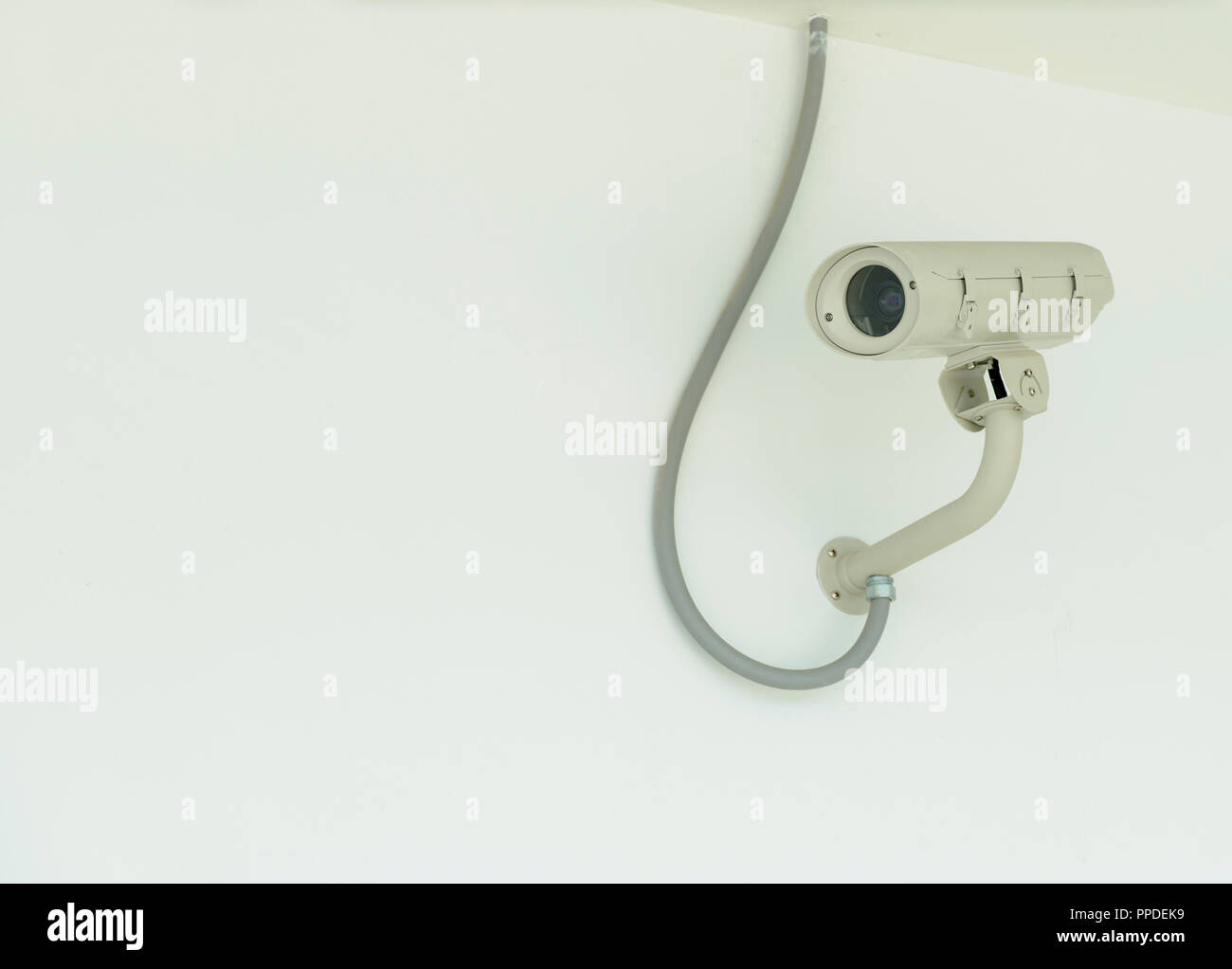 Security camera on the wall Stock Photo - Alamy