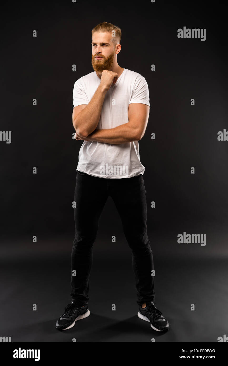 Full length portrait of a happy casual man standing isolated on a gray ...