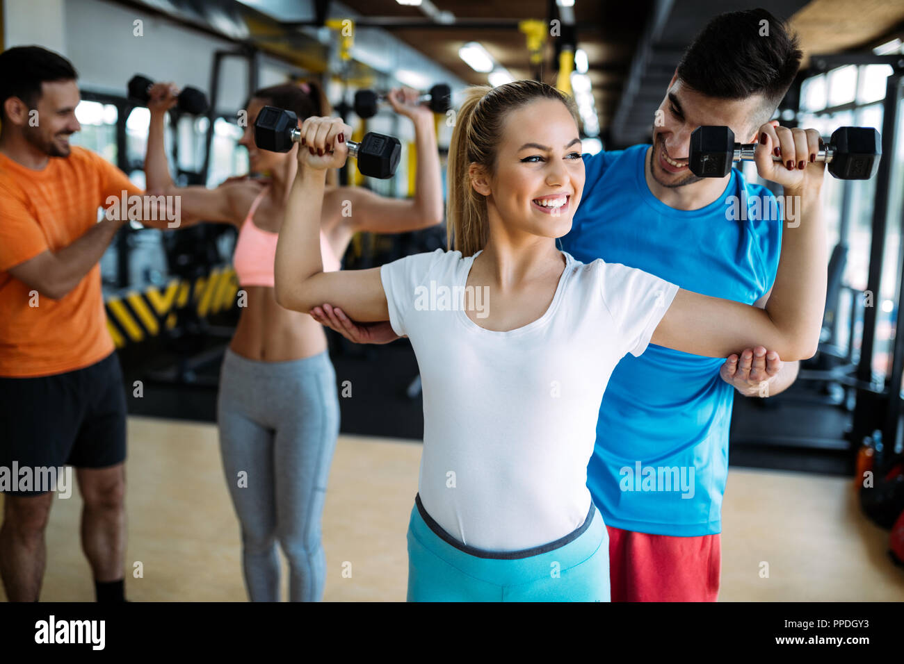 Personal trainer giving instructions in gym Stock Photo - Alamy