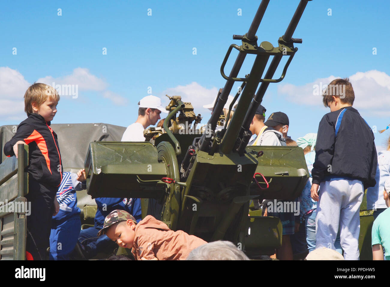 Children inspect and play on military vehicle Stock Photo - Alamy