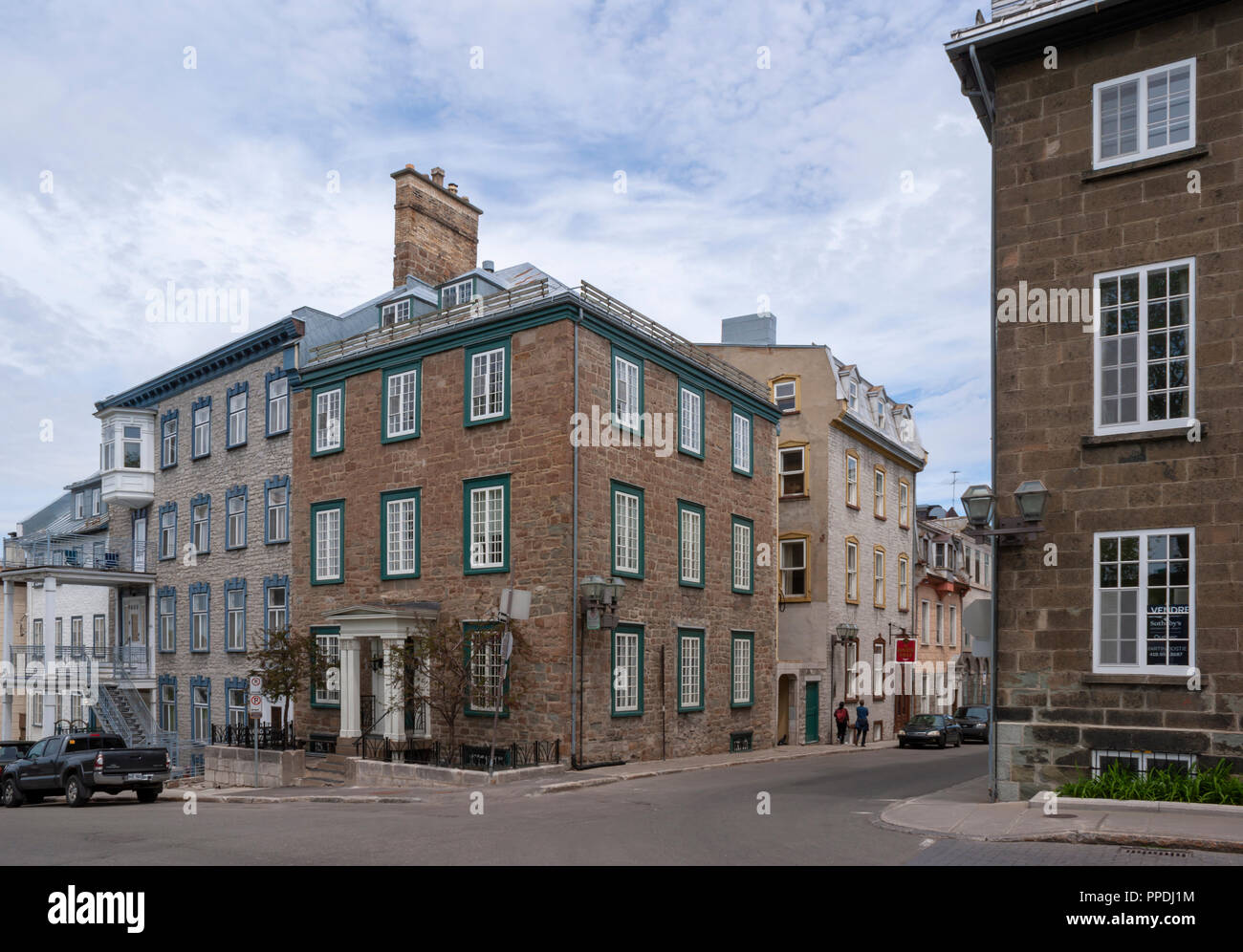 City quarter in Old Quebec with stone townhouses lining a street corner ...