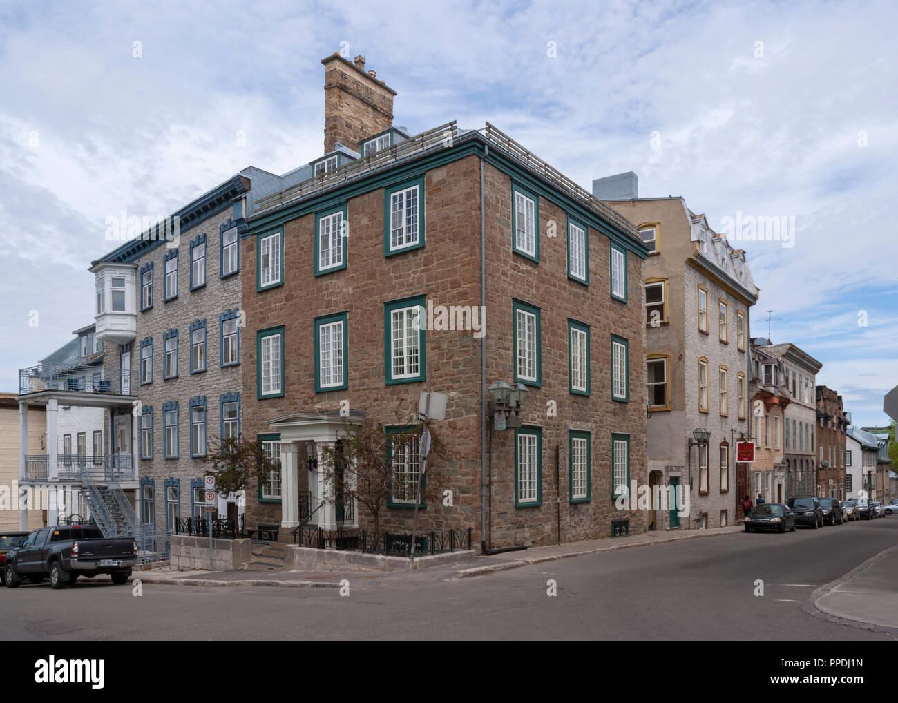 City quarter in Old Quebec with stone townhouses lining a street corner ...