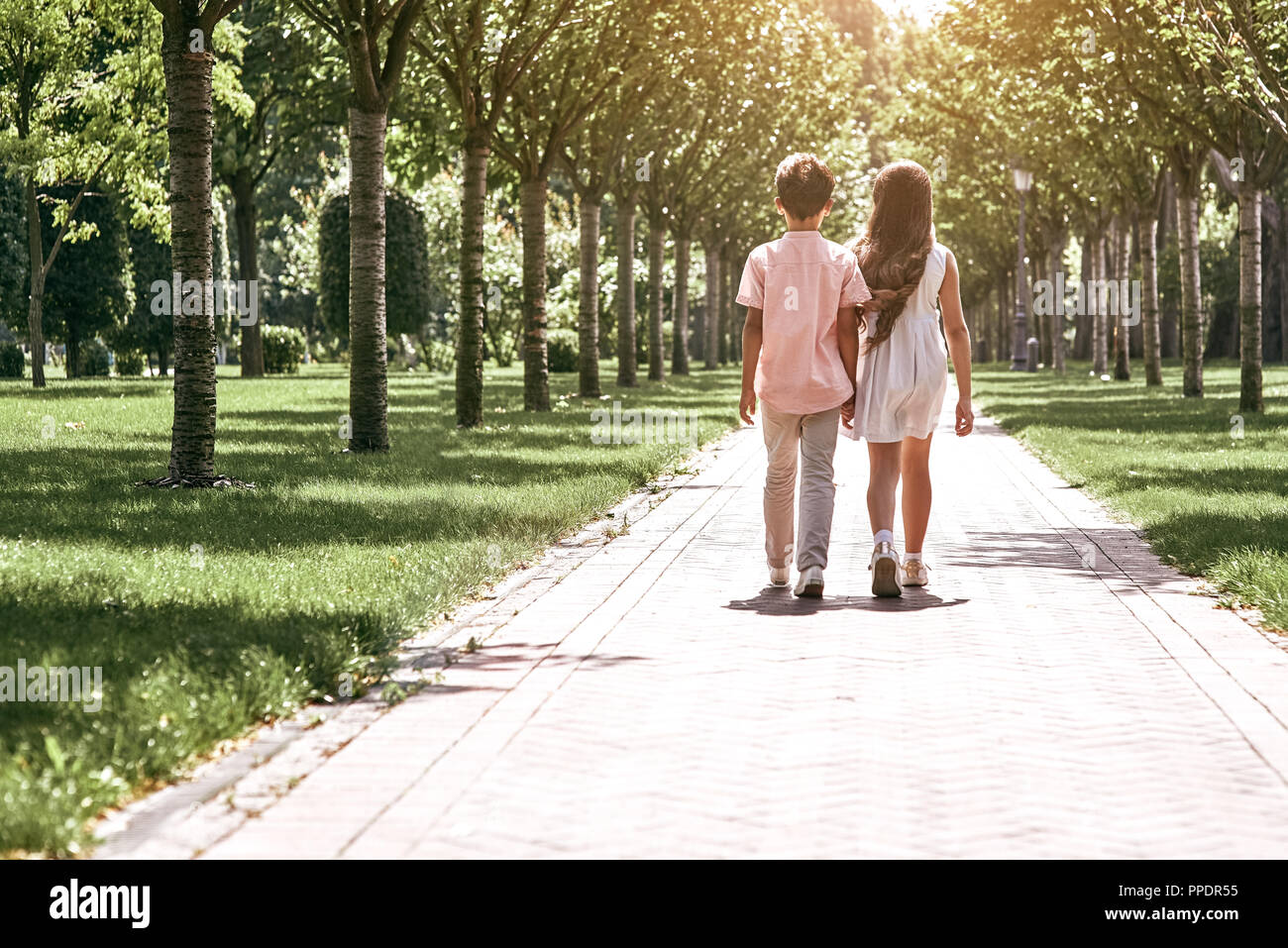 Boy and girl walking in road hi-res stock photography and images - Alamy
