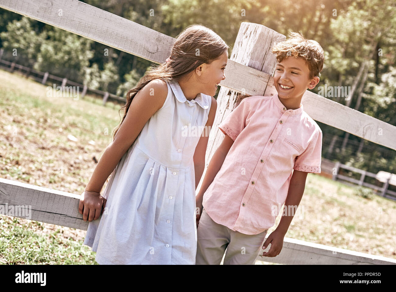 Friendship. Little boy and girl walking together outdoors leanin Stock Photo - Alamy