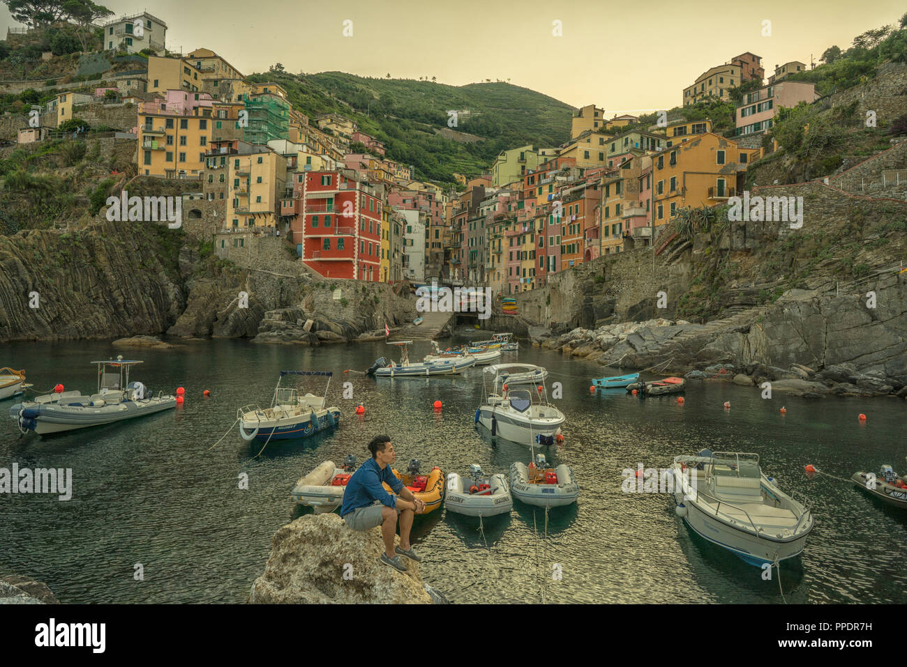 Sitting on the dock of the bay Cinque Terre, Italy Stock Photo - Alamy