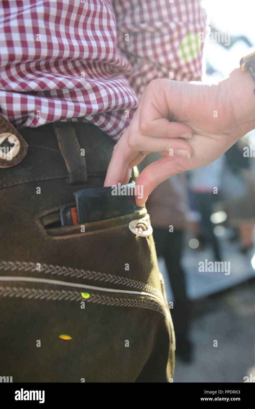A pickpocket steals the purse of an Oktoberfest visitor from the pocket ...