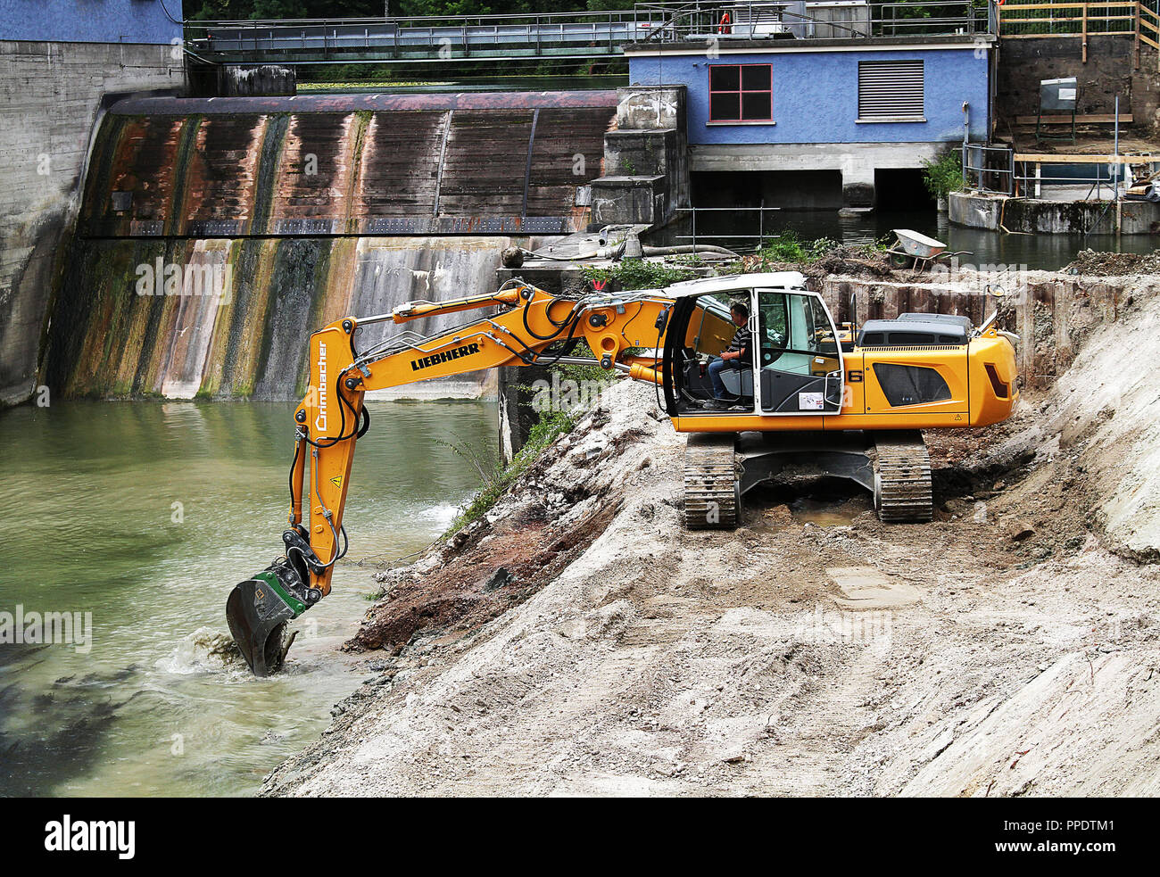 An excavator during the construction of a fish ladder at the old weir ...