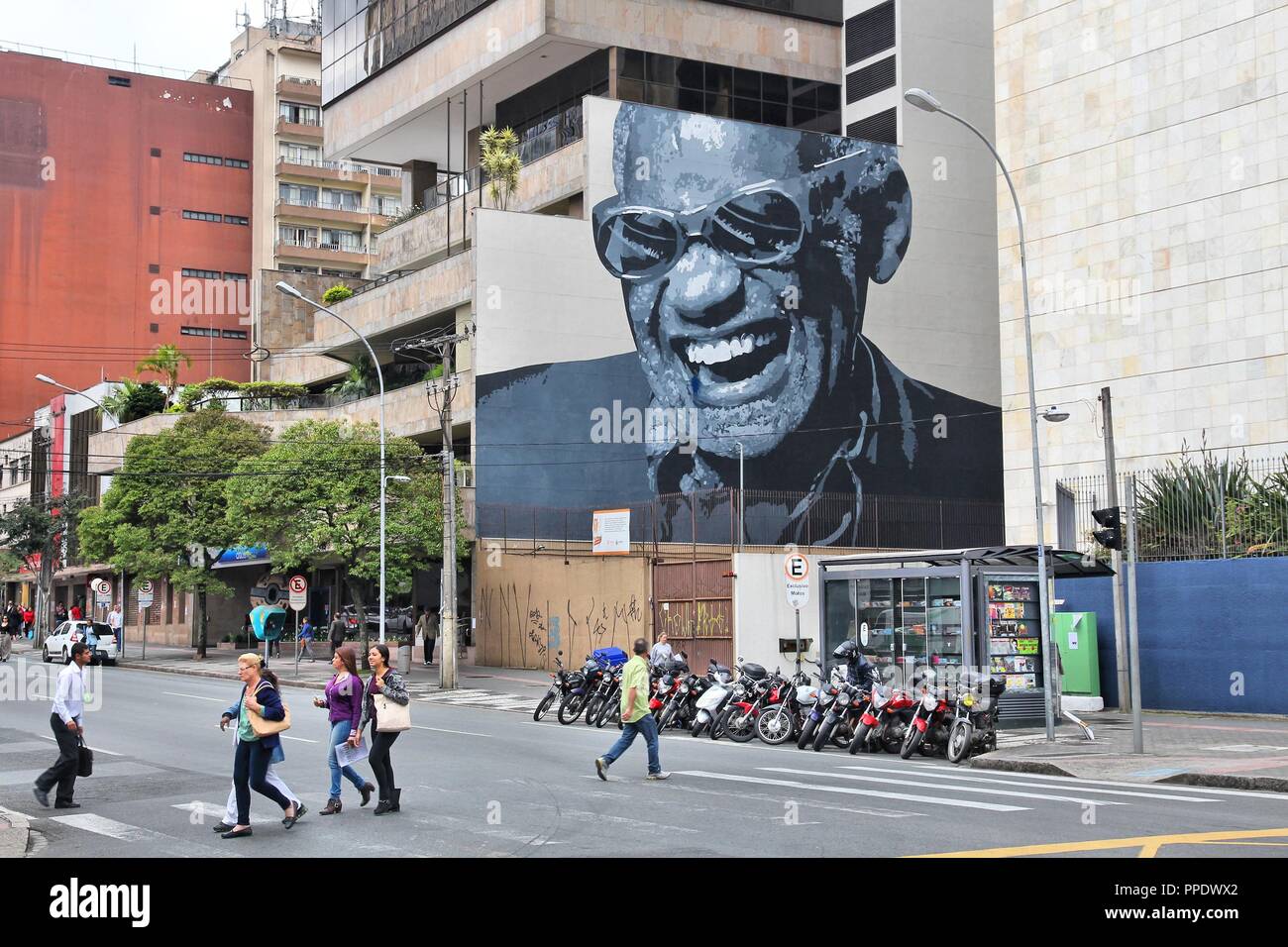 CURITIBA, BRAZIL - OCTOBER 7, 2014: People walk under Ray Charles urban ...
