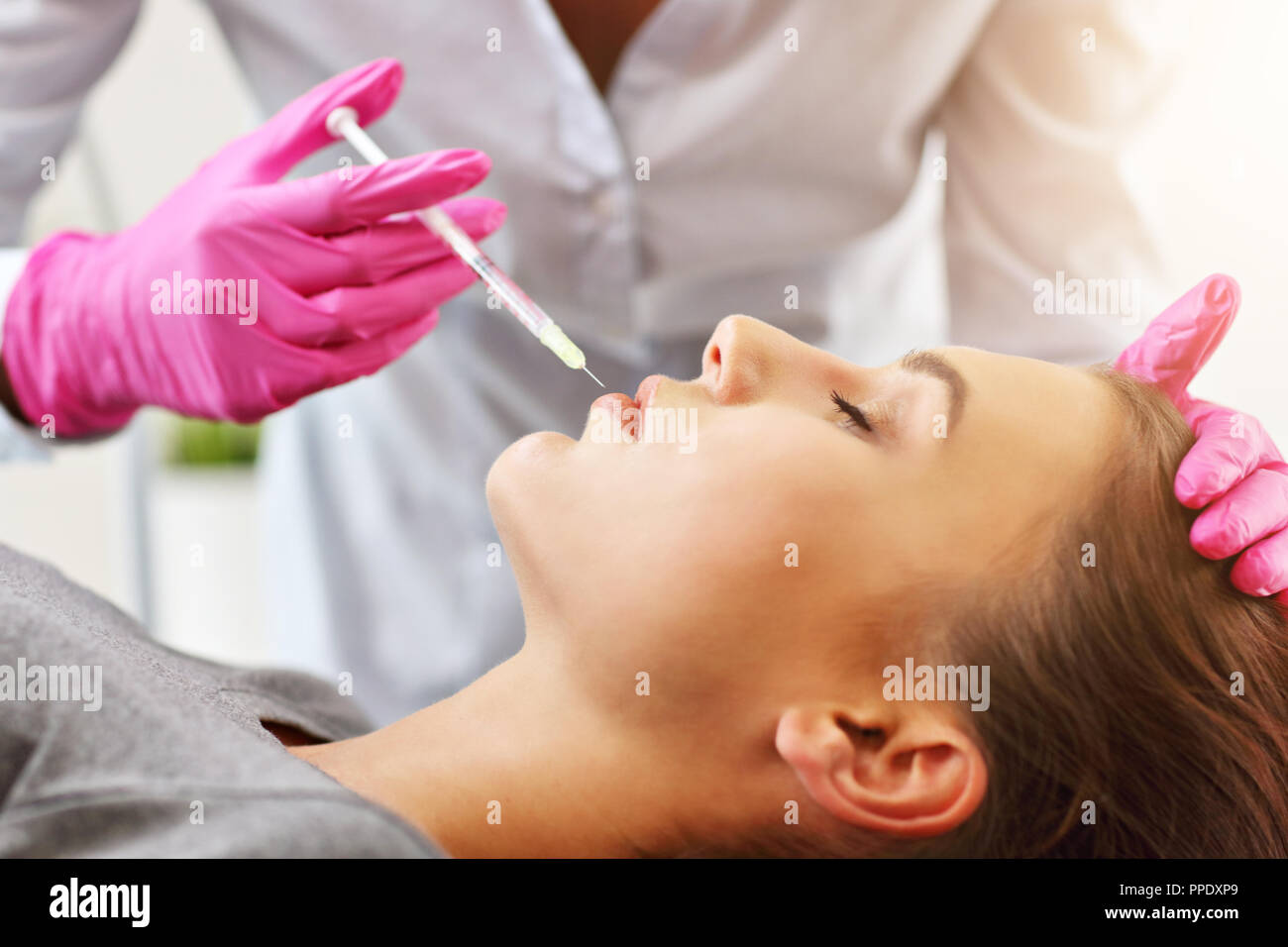 Attractive young woman gets cosmetic face injection Stock Photo - Alamy