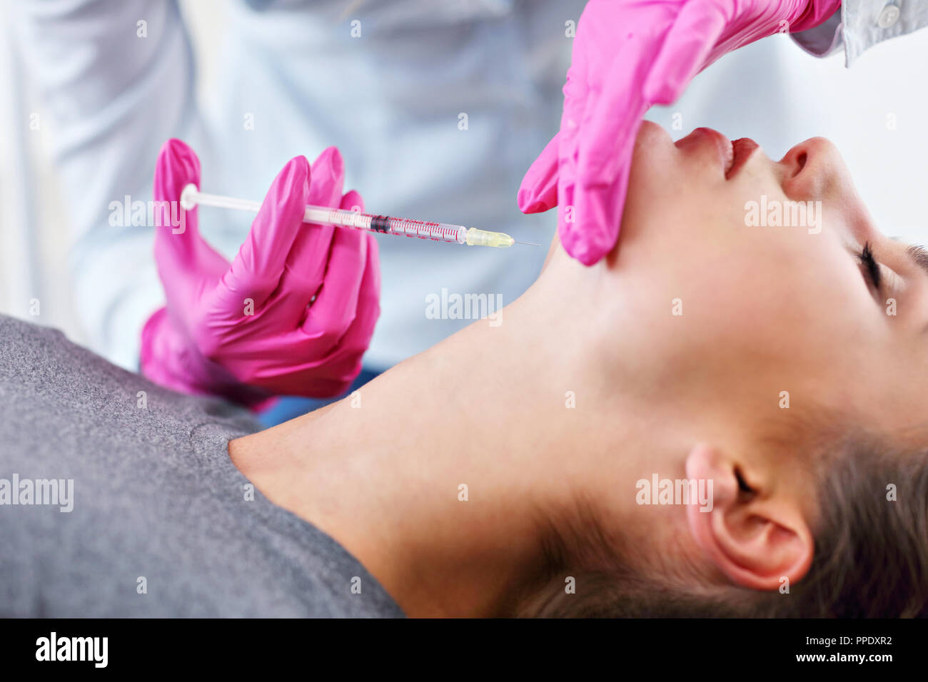 Attractive young woman gets cosmetic face injection Stock Photo - Alamy