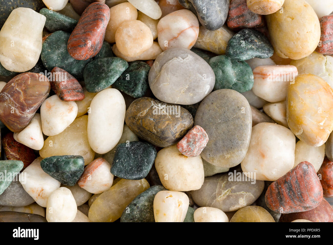 Background texture of assorted colorful natural smooth waterworn beach ...
