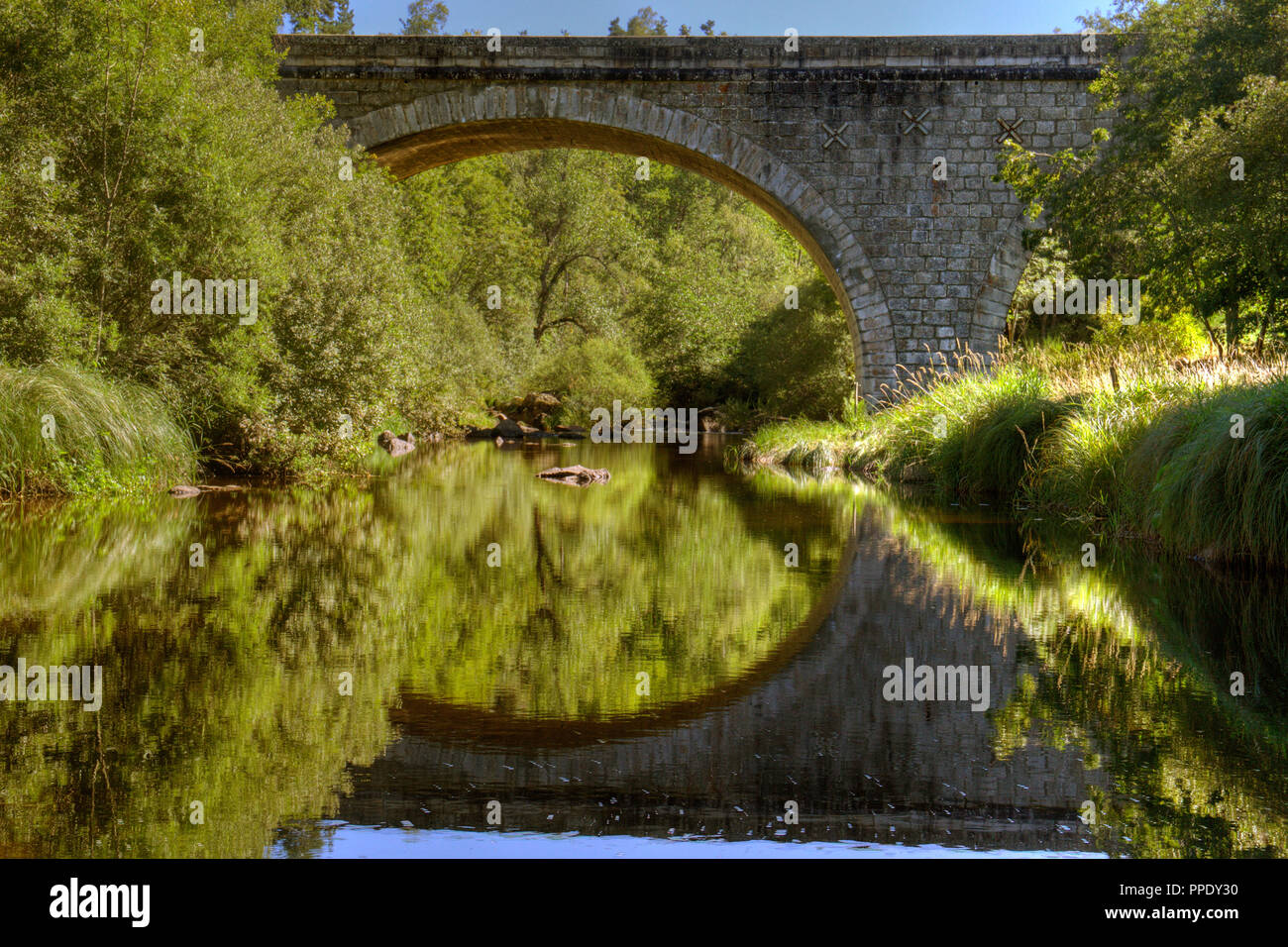 Stone arch bridge ‘Pont de Braye’ over the river Chapeauroux in Lozère ...