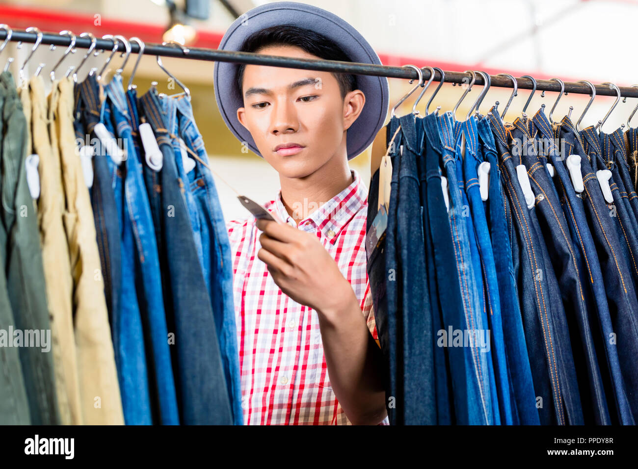 Man looking at price tag Stock Photo - Alamy