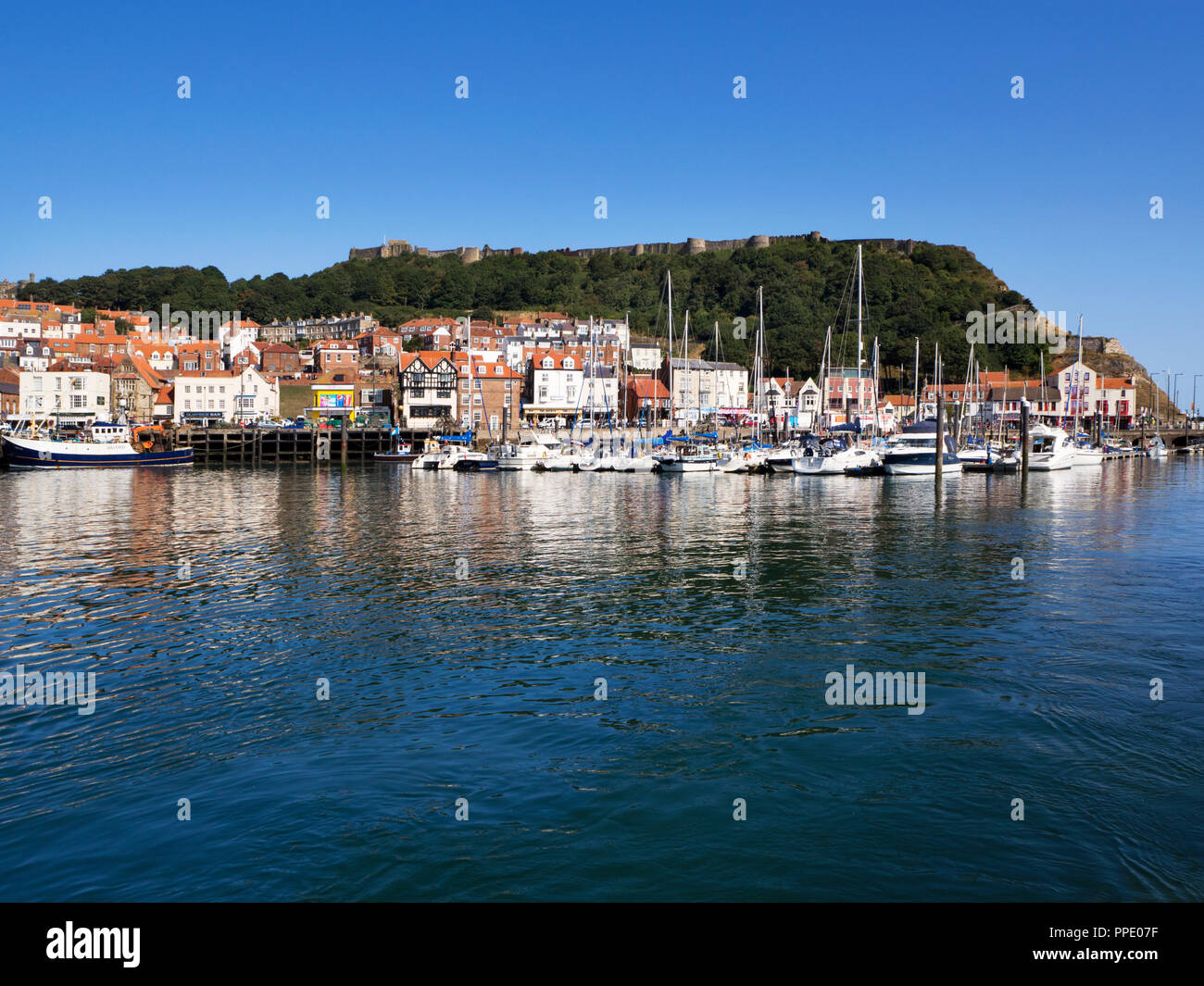 Boats at the harbour and Sandside seafront buildings below Castle Hill ...