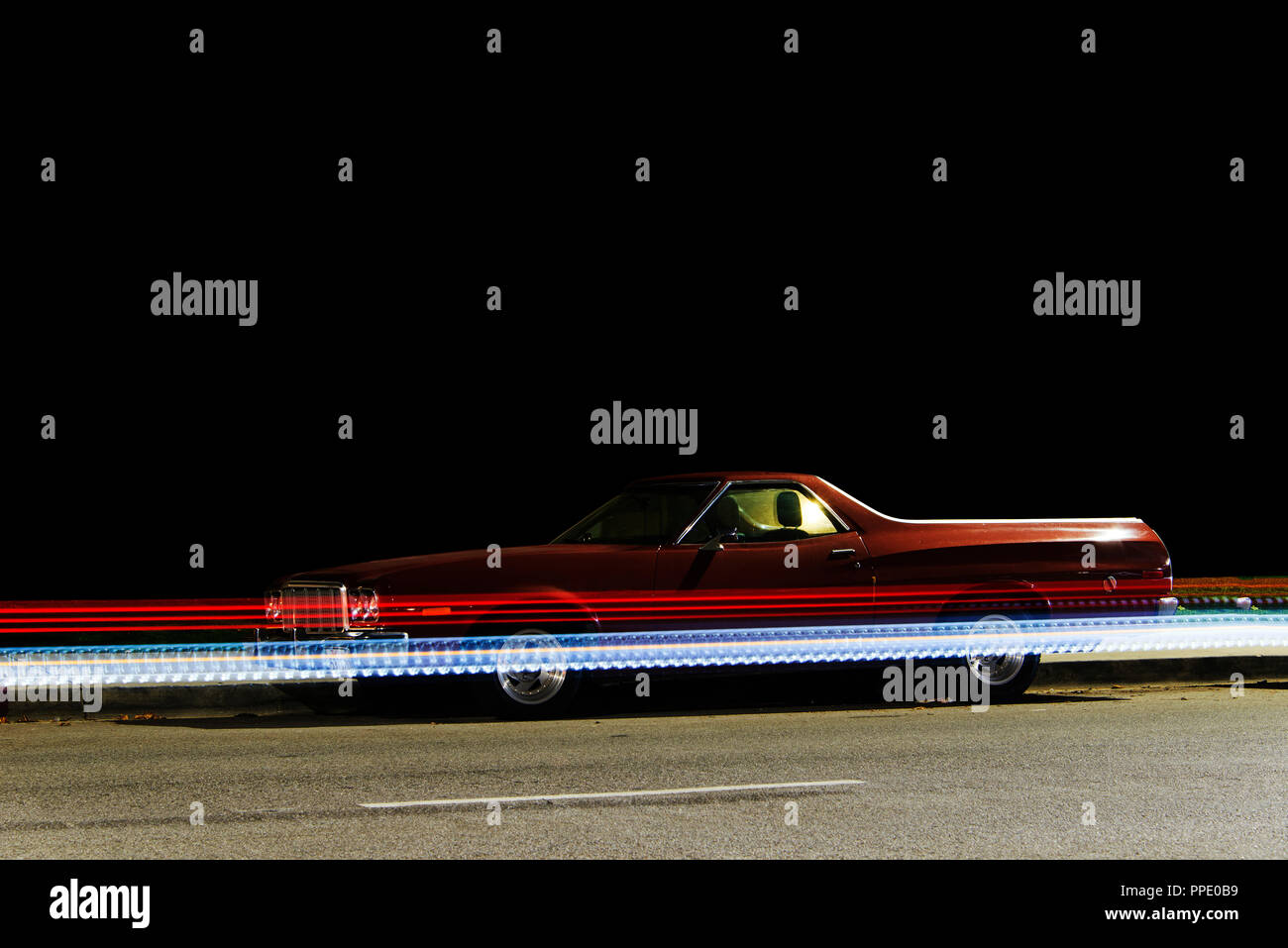 Side view of a vintage classic pick up truck car and light trails ...
