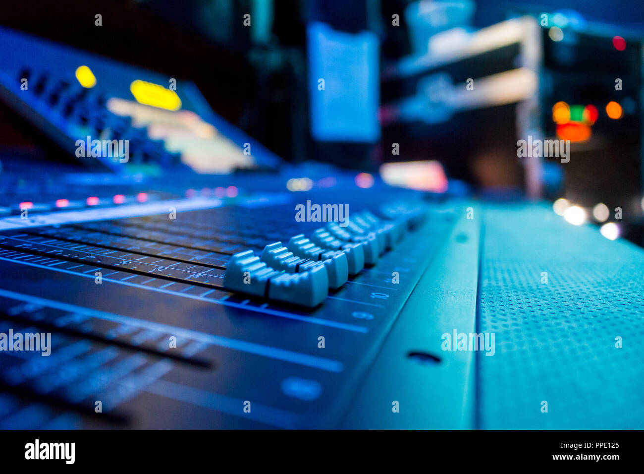 Low level view of a professional audio mixing console with rack ...