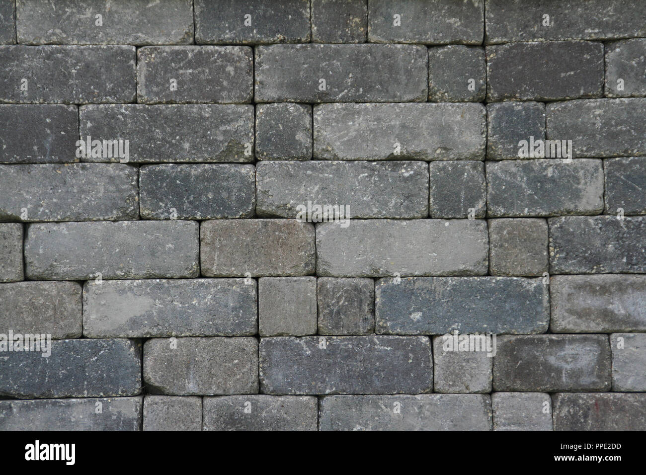Different shades of grey bricks making up a wall Stock Photo - Alamy