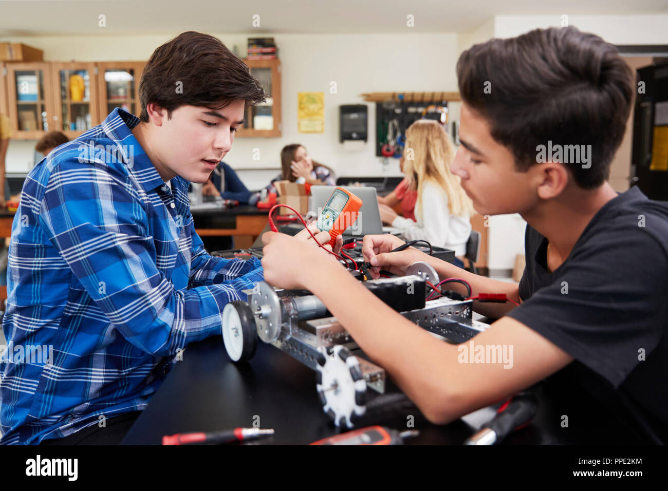 Two Male Pupils Building Robotic Vehicle In Science Lesson Stock Photo ...