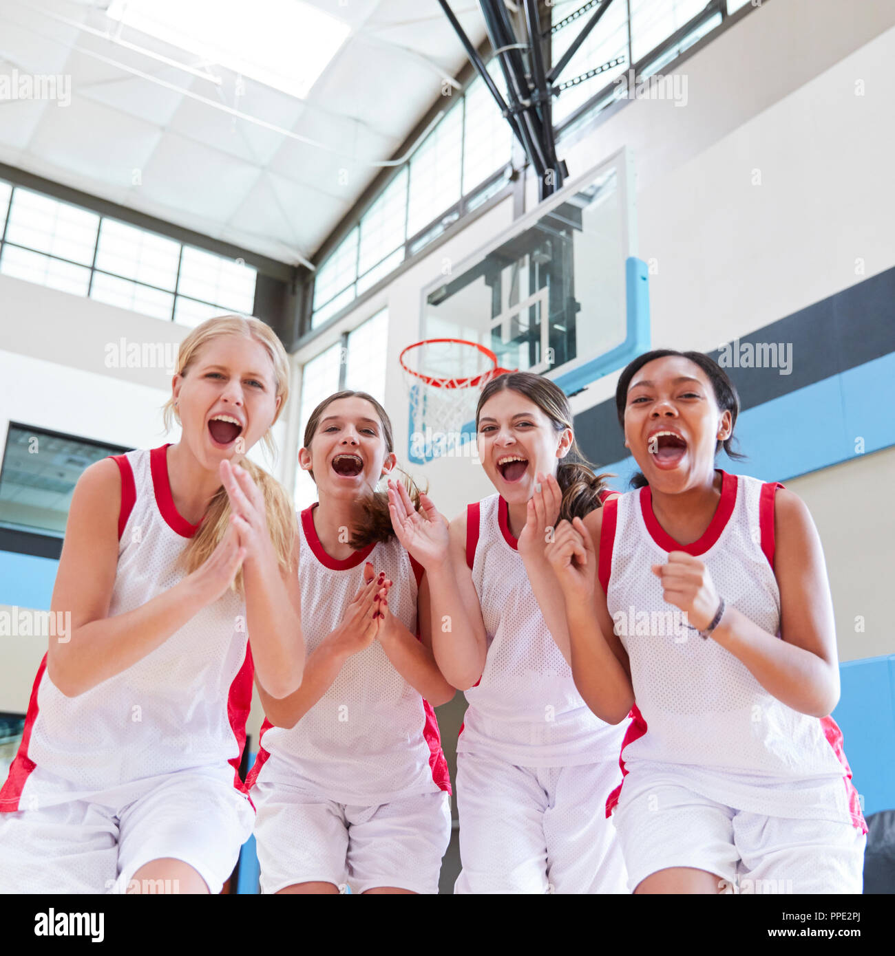 Portrait Of Female High School Basketball Team Celebrating On Court ...
