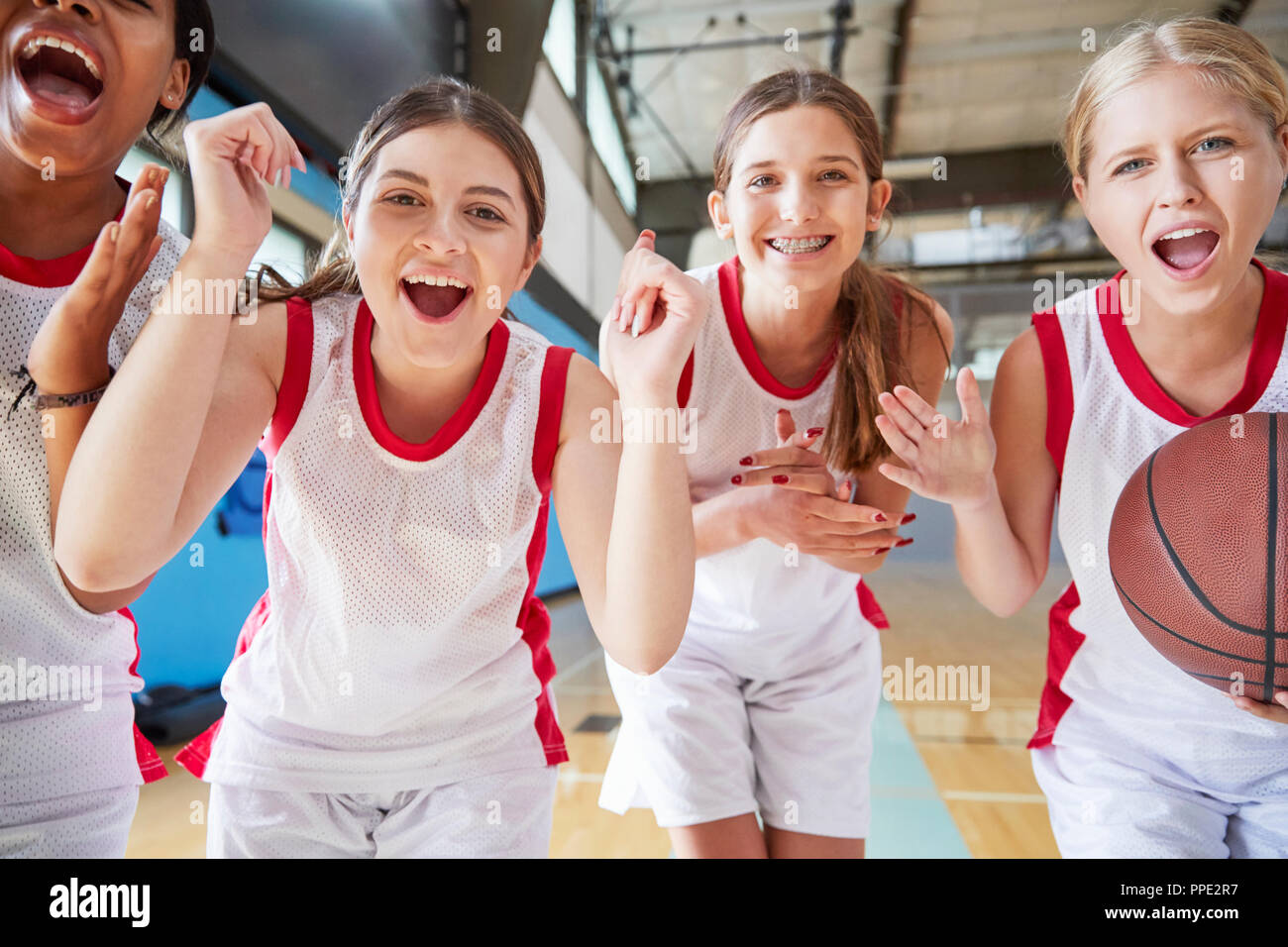 Portrait Of Female High School Basketball Team Celebrating On Court ...
