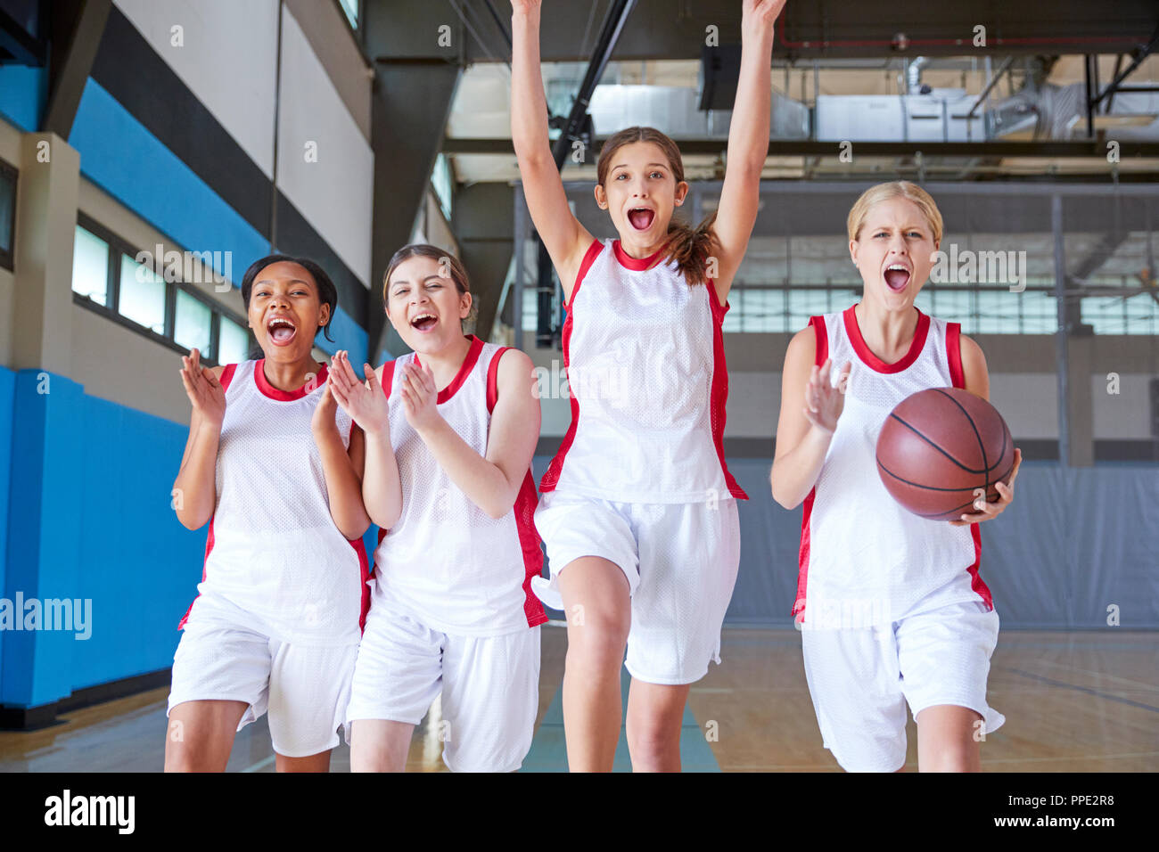 Portrait Of Female High School Basketball Team Celebrating On Court ...