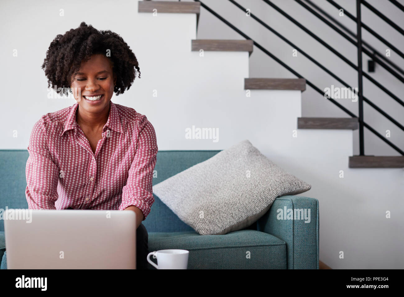 Woman home sitting on the sofa working laptop hi-res stock photography ...