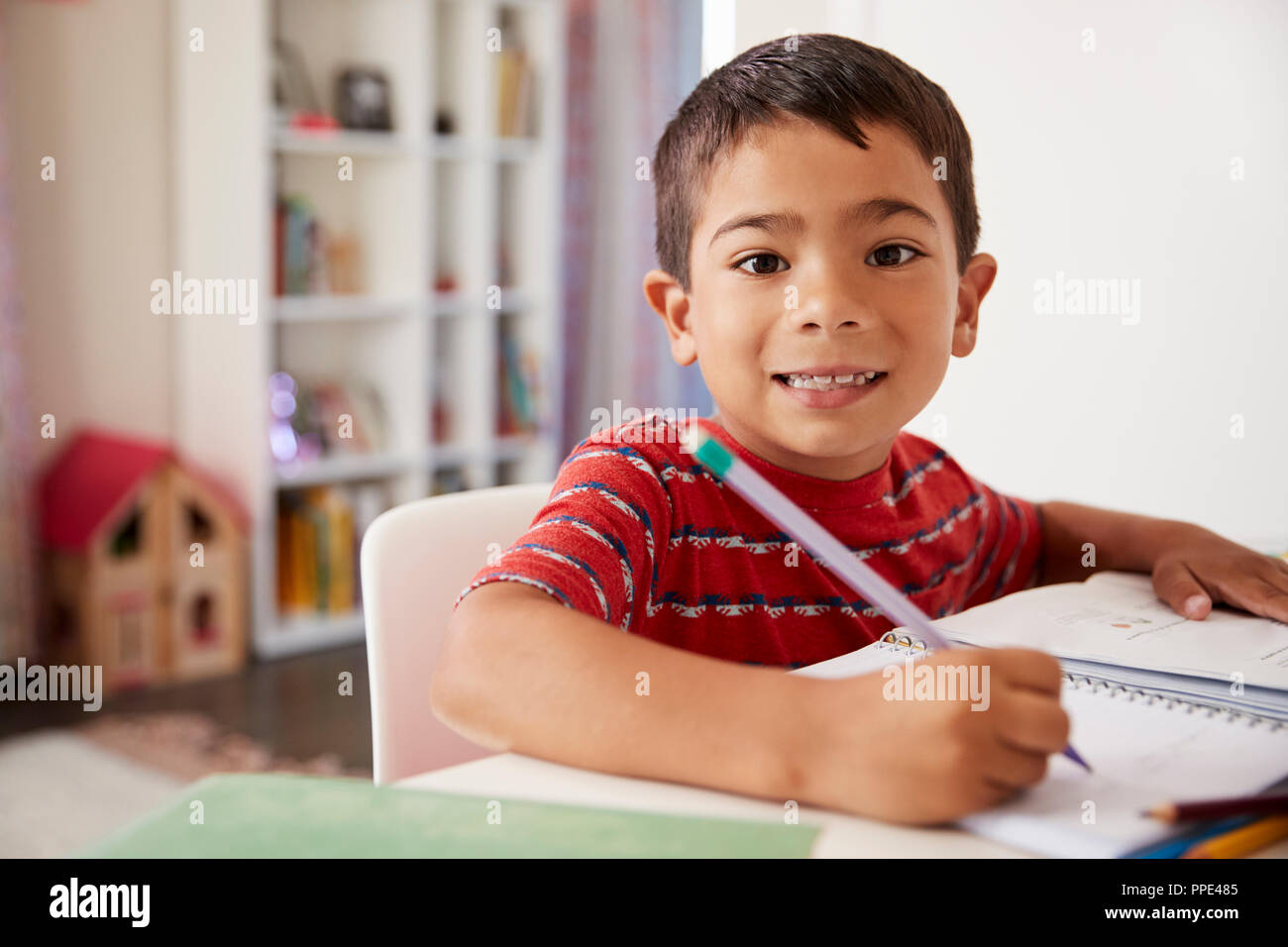 Boy sitting desk homework hi-res stock photography and images - Alamy