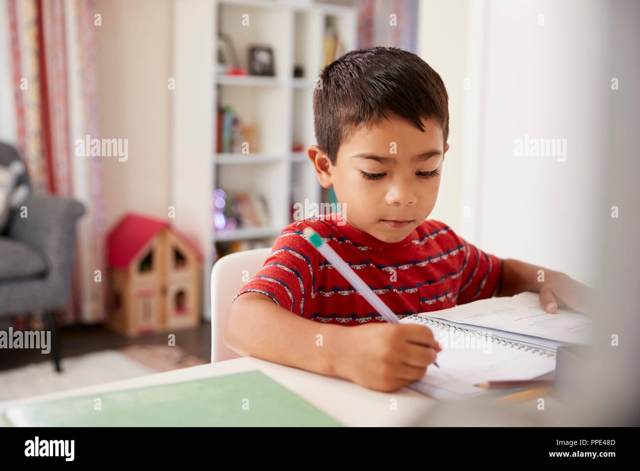 Boy sitting at desk hi-res stock photography and images - Alamy