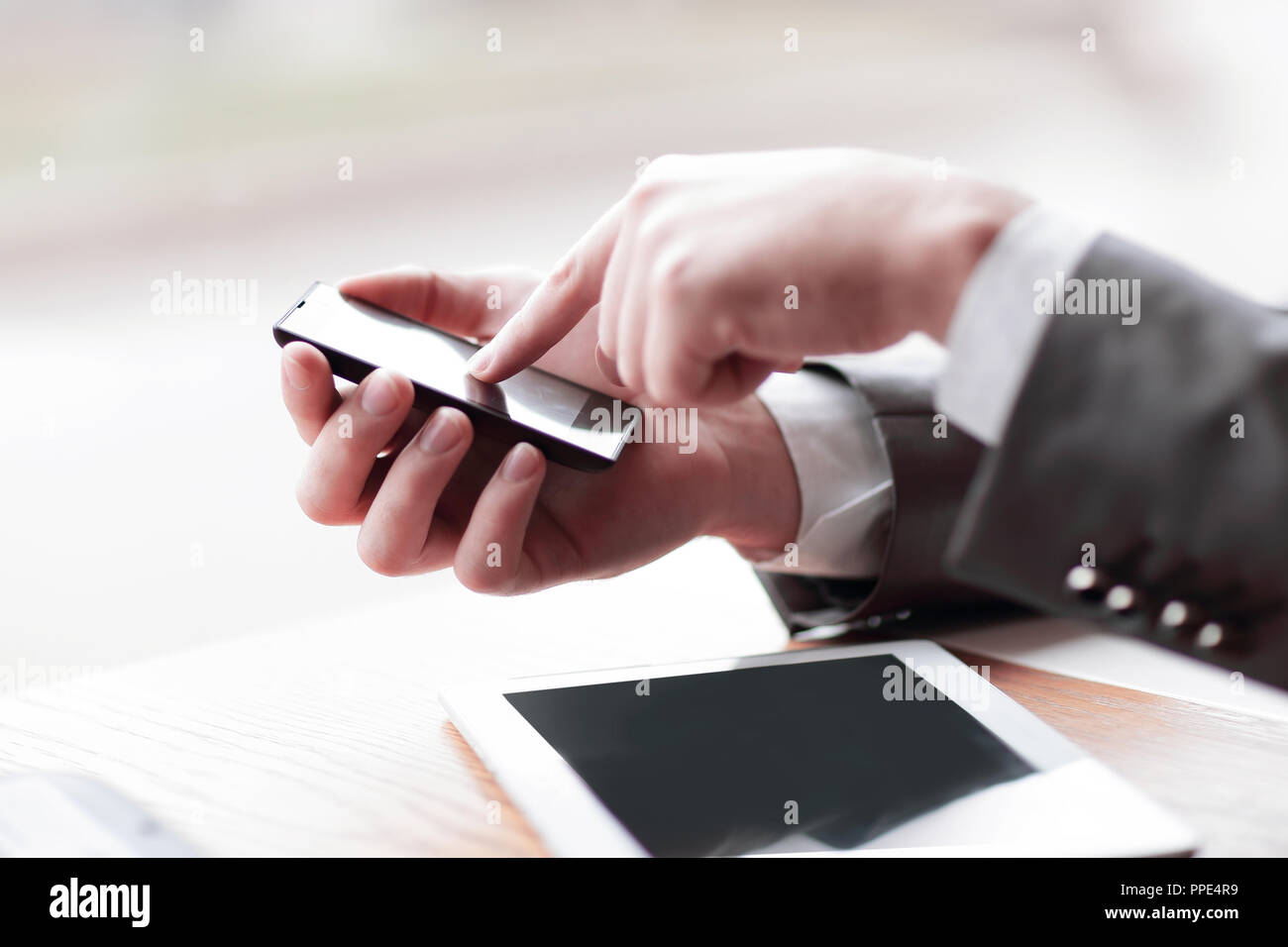 close up.businessman presses his finger on the screen of the sma Stock ...