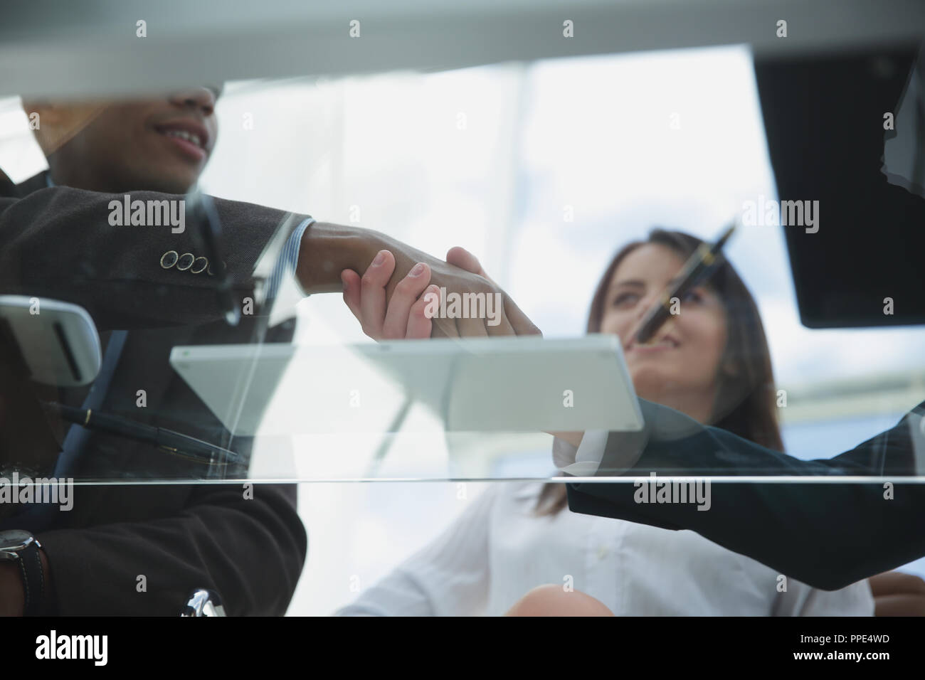 bottom view.the handshake business partners for their Desk Stock Photo ...