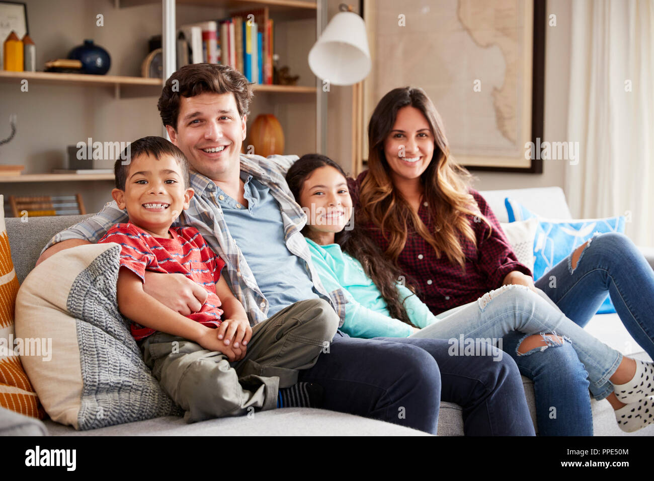 Family relaxing on sofa hi-res stock photography and images - Alamy