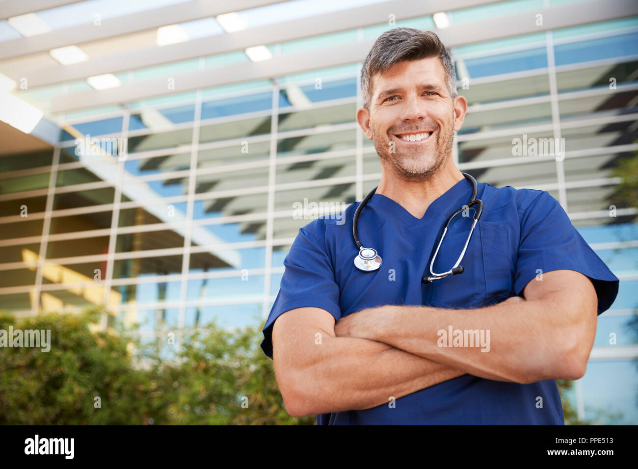 Happy male healthcare worker smiling to camera outdoors Stock Photo - Alamy