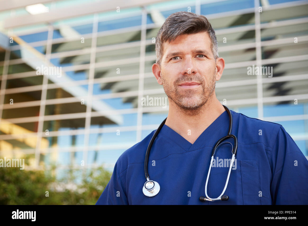 White male healthcare worker outside modern hospital Stock Photo - Alamy