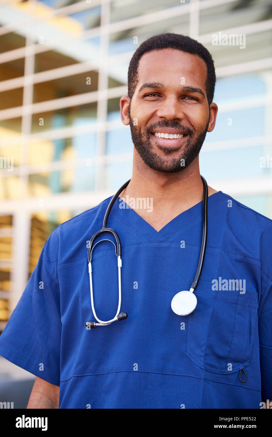 Young black male healthcare worker smiling outside, vertical Stock ...