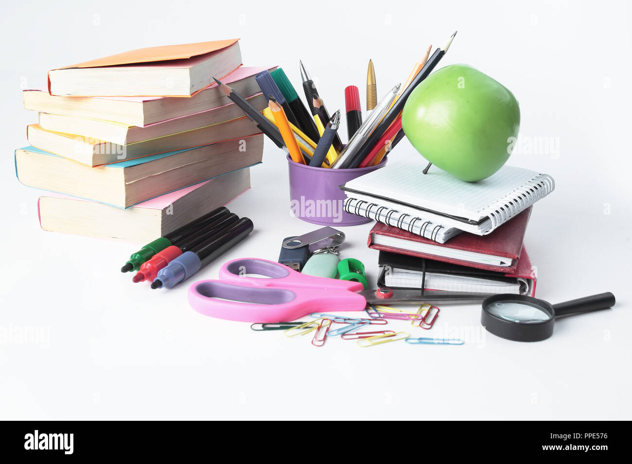 textbooks and a variety of school supplies on white background .concept ...