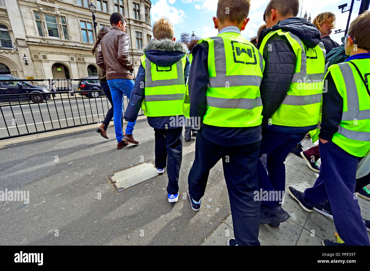 Schoolchildren in hi-vis vests on a school trip, Parliament Square ...