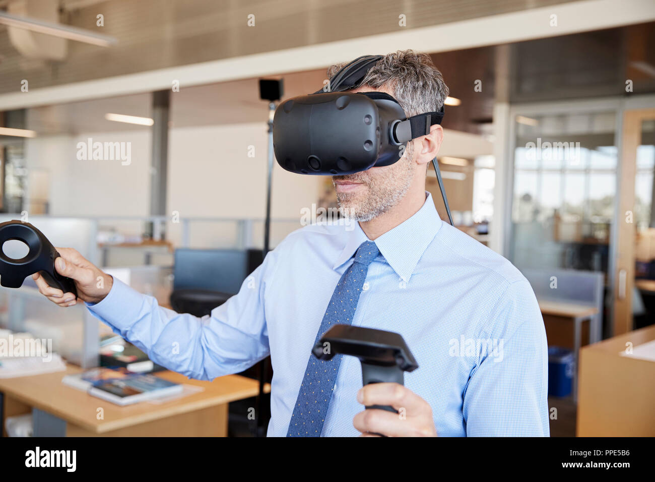 Businessman using VR technology in an office, close up Stock Photo - Alamy