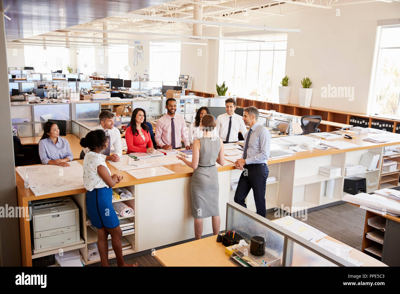 Informal team meeting in an open plan office, elevated view Stock Photo ...
