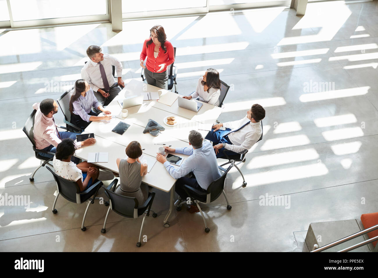Businesswoman addressing team meeting, elevated view Stock Photo - Alamy