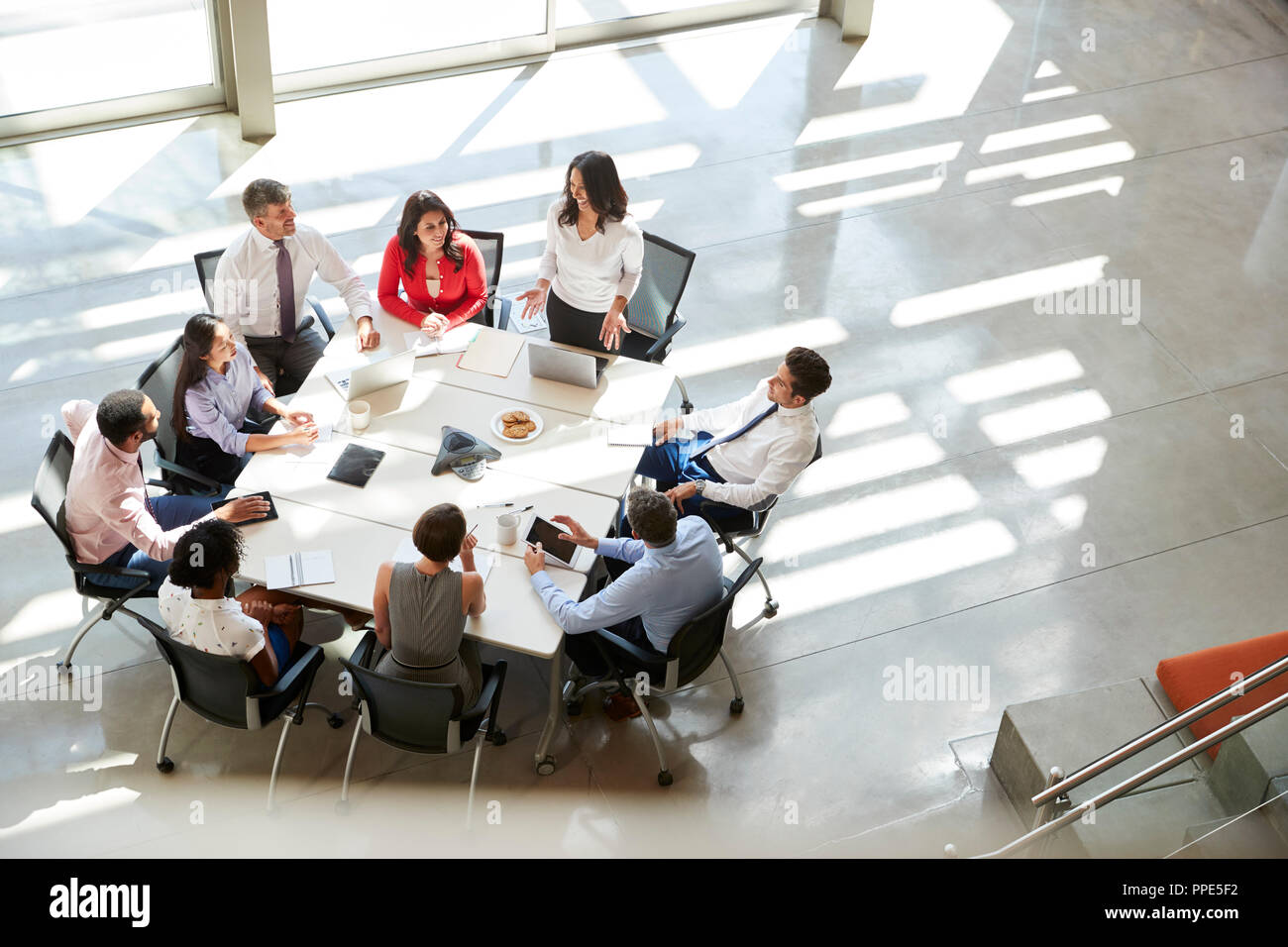 Businesswoman addressing team meeting, elevated view Stock Photo - Alamy