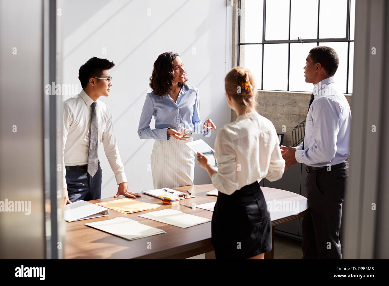 Four business colleagues working together in a small office Stock Photo ...