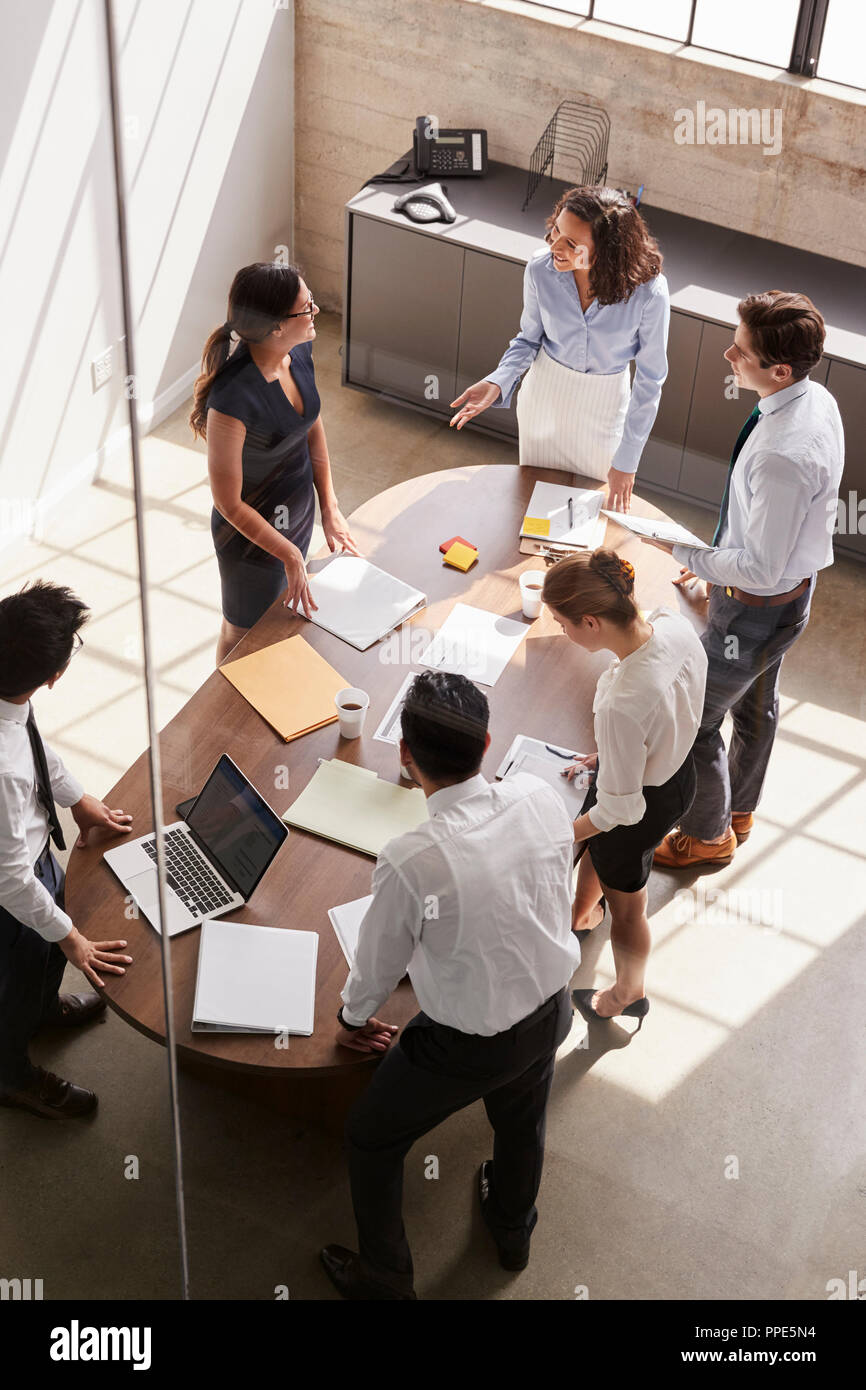 Female manager in team meeting, elevated view through window Stock ...