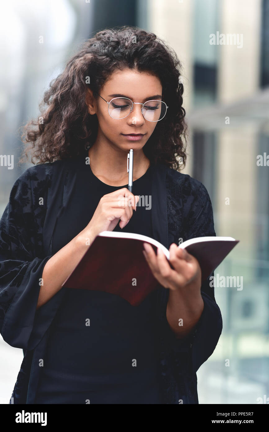 Young woman making notes walking hi-res stock photography and images ...