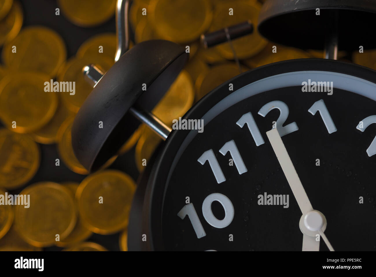 Alarm clock and coins stacks on working table, time for savings money ...