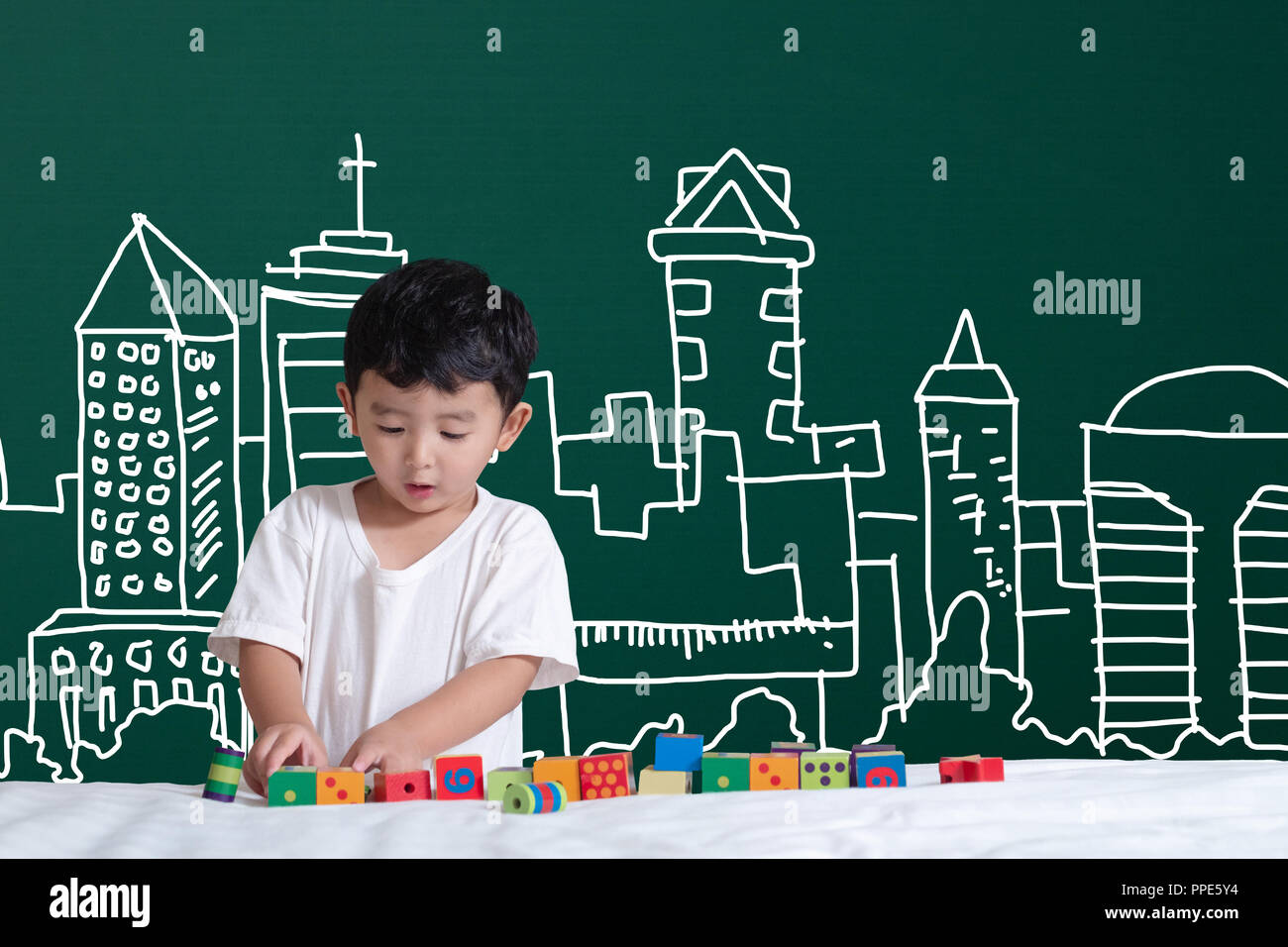 Asian kid learning by playing with his imagination about building and ...