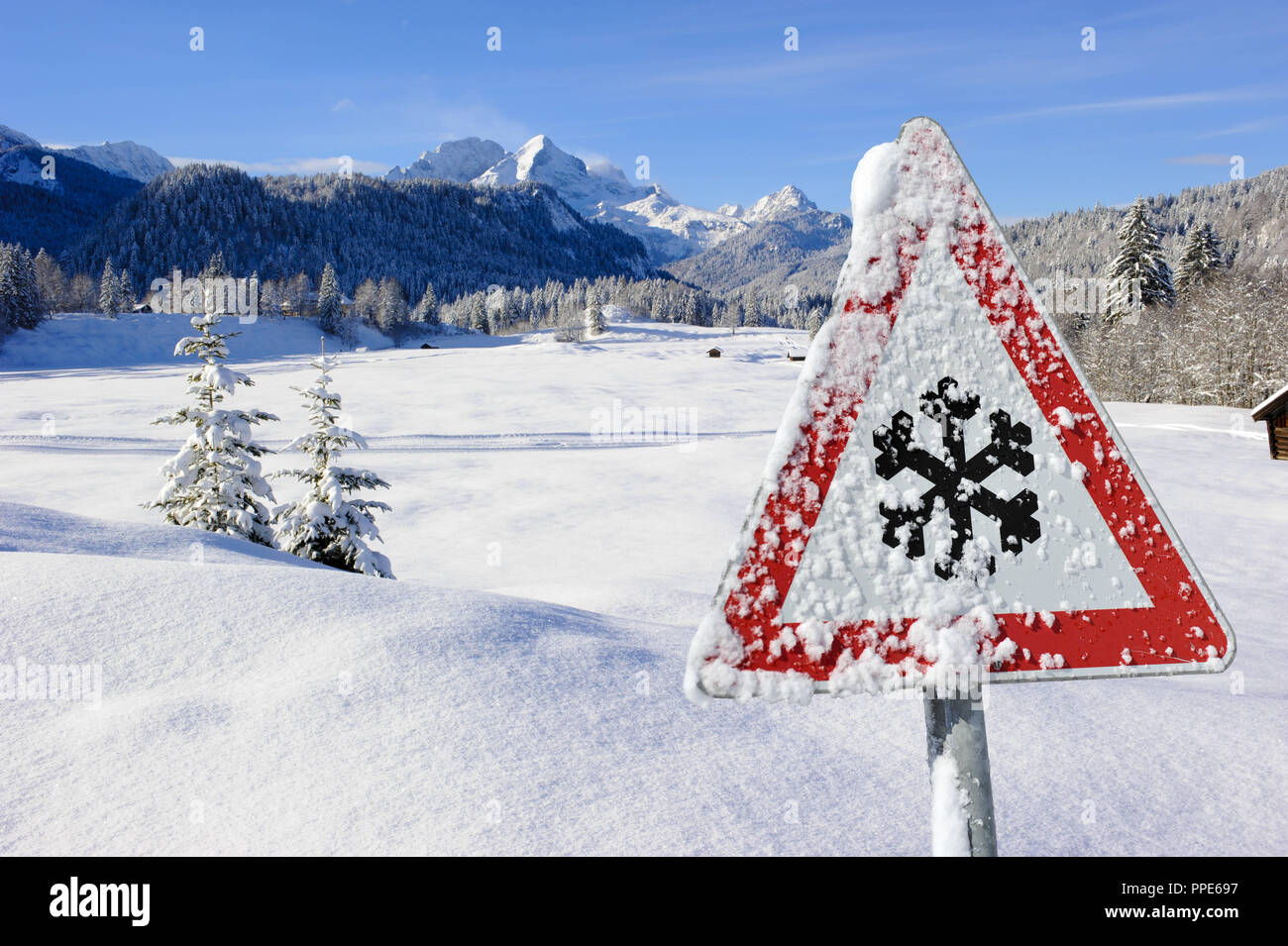 Warning sign on a road against ice, snow and icy conditions Stock Photo ...
