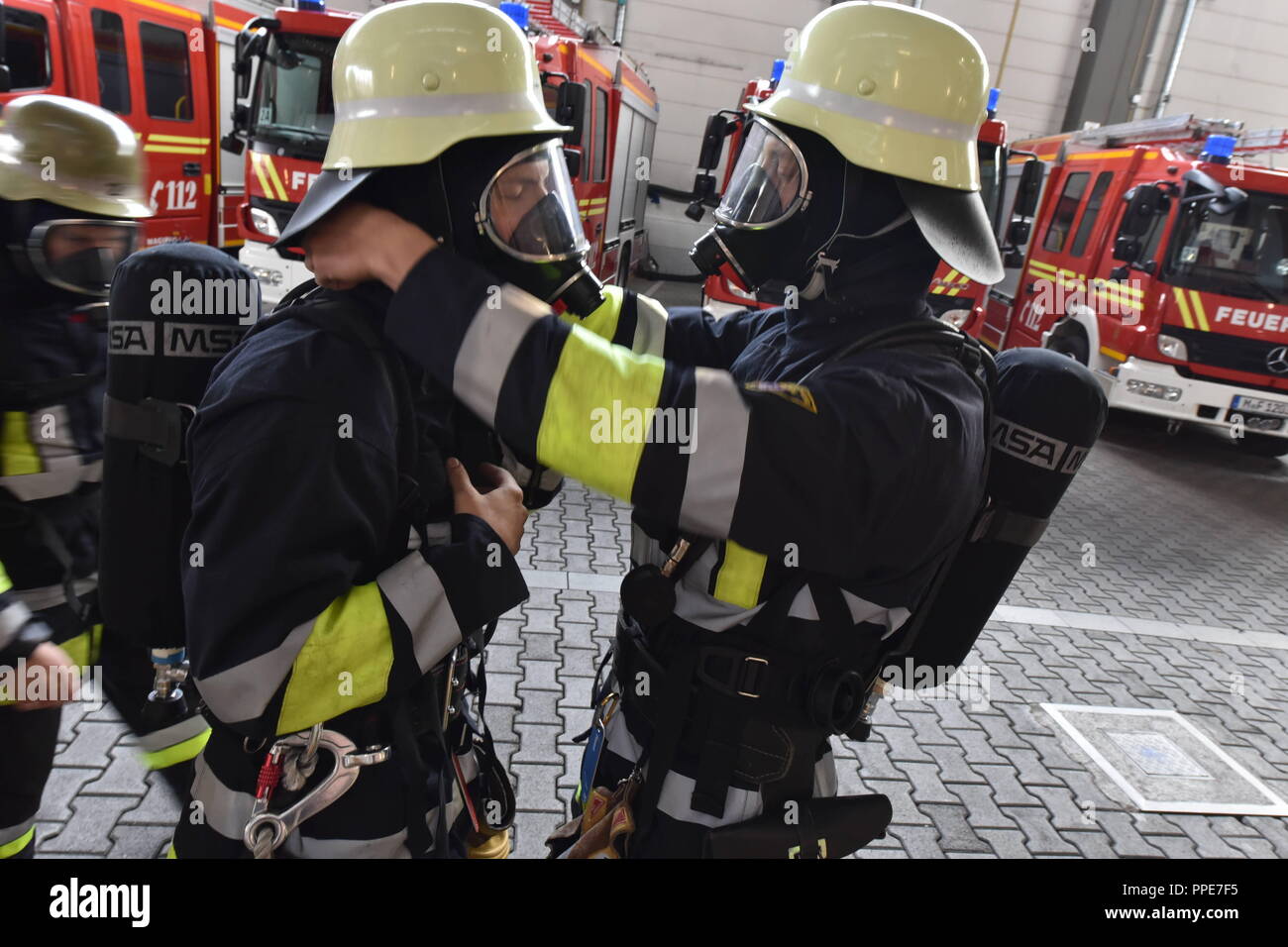 Firefighter students practise for an emergency in the fire station in ...