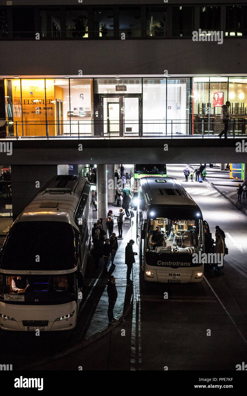Passengers and buses in the Central Bus Station Munich (ZOB) at the ...